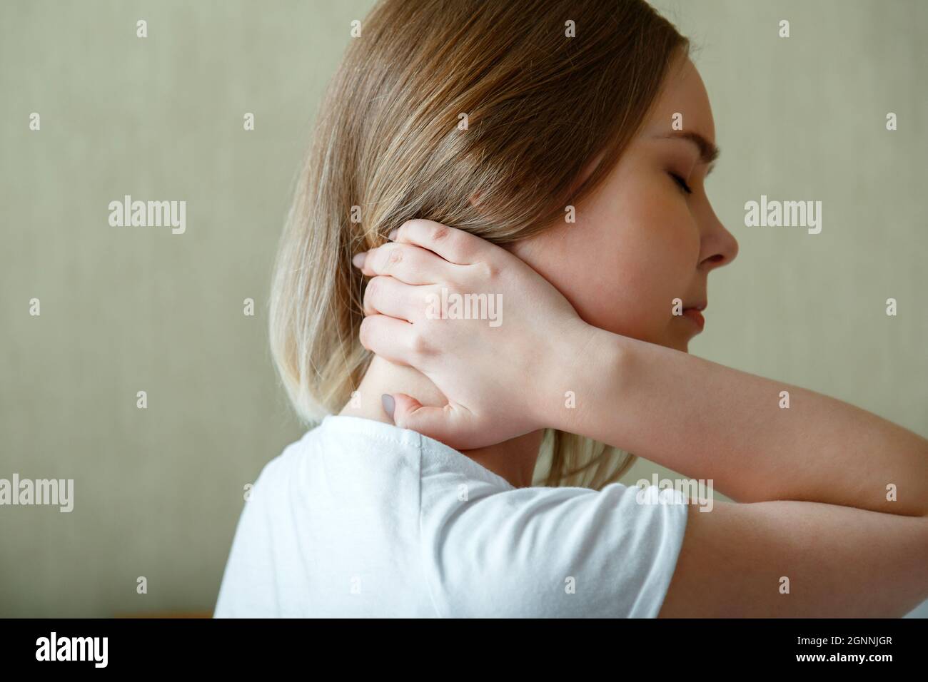 Woman holds neck with pain cervical muscle spasm by hand. Neck pain ...