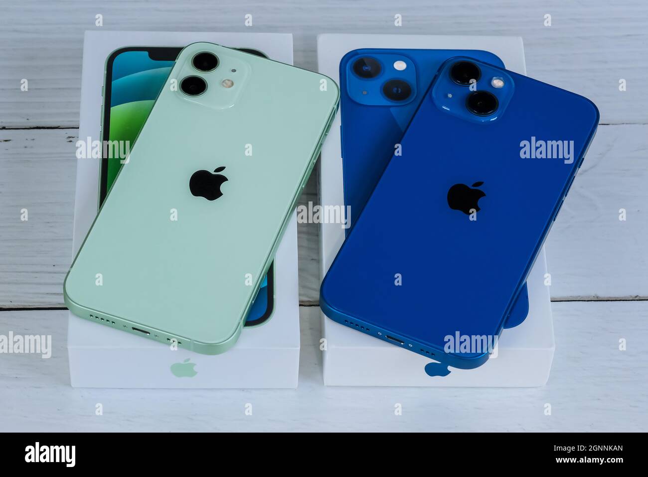iPhone 13 in blue and iPhone 12 in green Stock Photo - Alamy