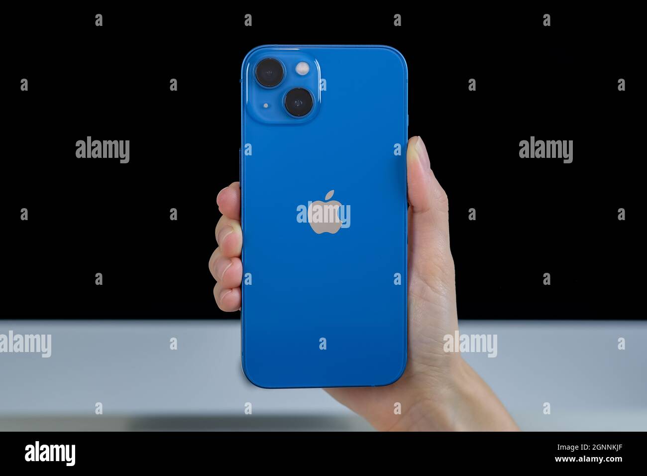 iPhone 13 in blue Stock Photo - Alamy