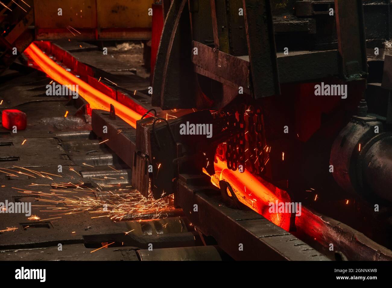 Red-hot metal billet on the roller table of a rolling mill Stock Photo ...