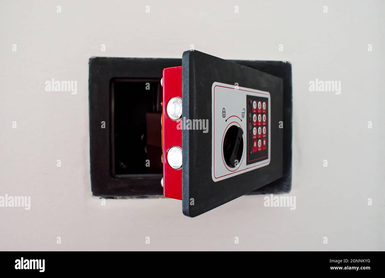 Home safe with digital keypad on white wall Stock Photo - Alamy