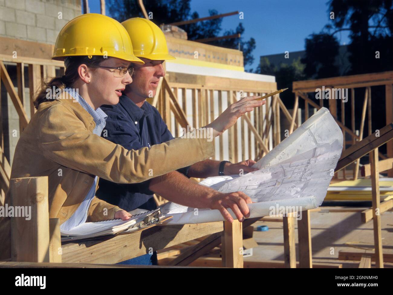 Architect and contractor discuss plan at construction site, Los Angeles ...