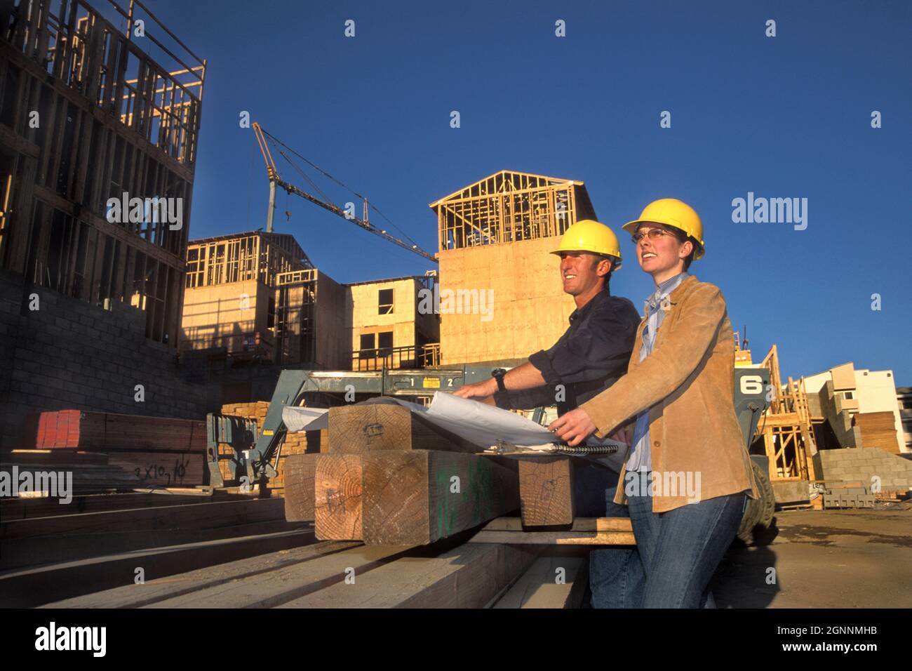 Architect and contractor discuss plan at construction site7, Los ...
