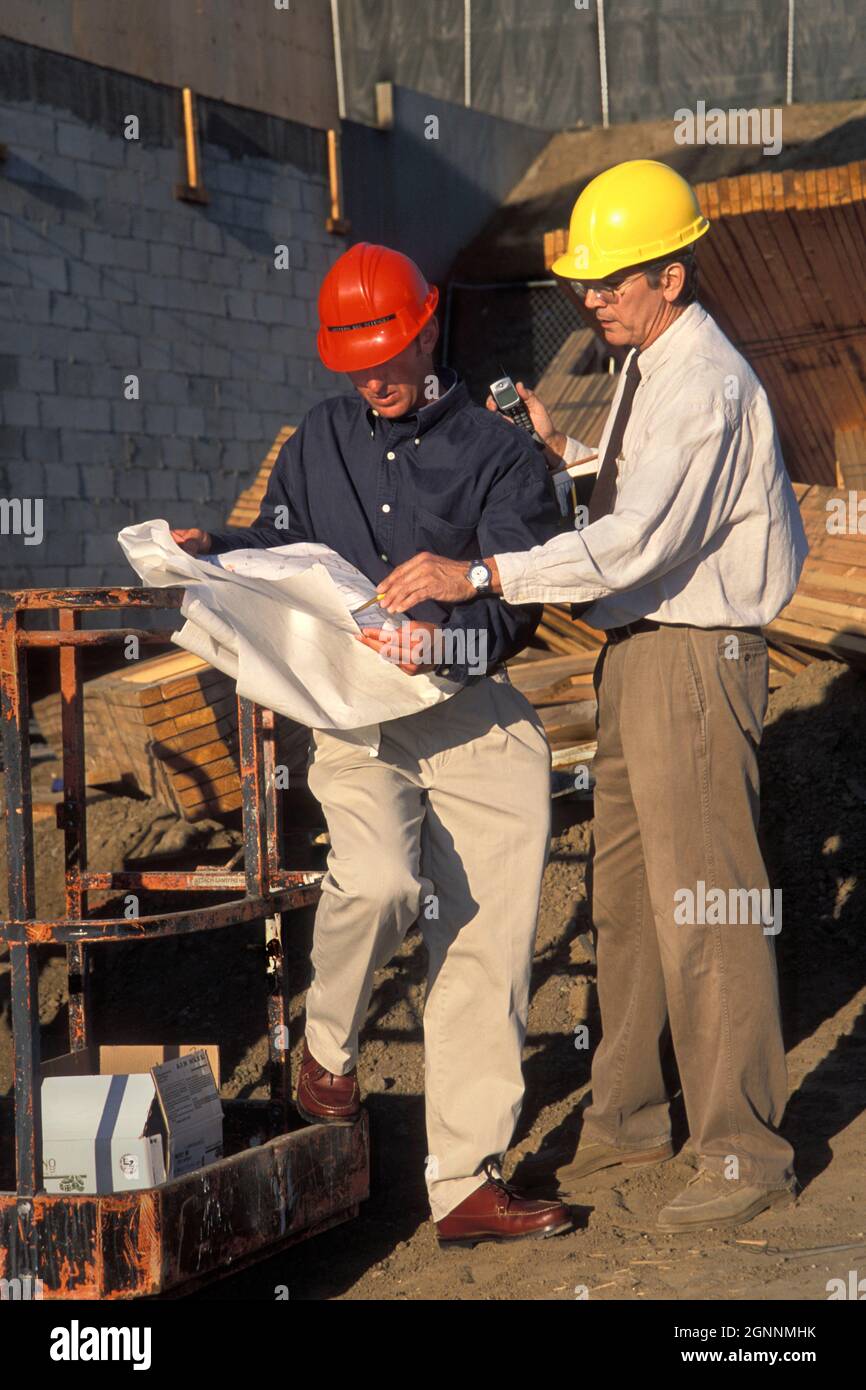 Architect and contractor discuss plan at construction site11, Los ...