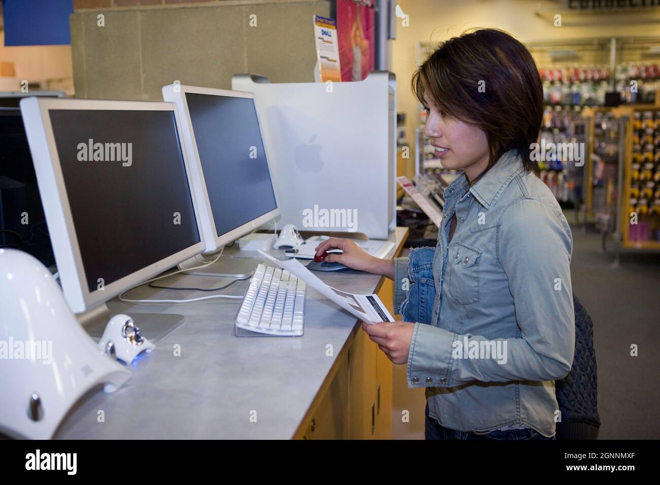 A young Asian woman shops for a new computer in Los Angeles, CA MR ...