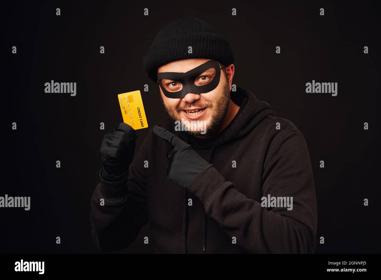 Funny thief holding credit card Stock Photo - Alamy