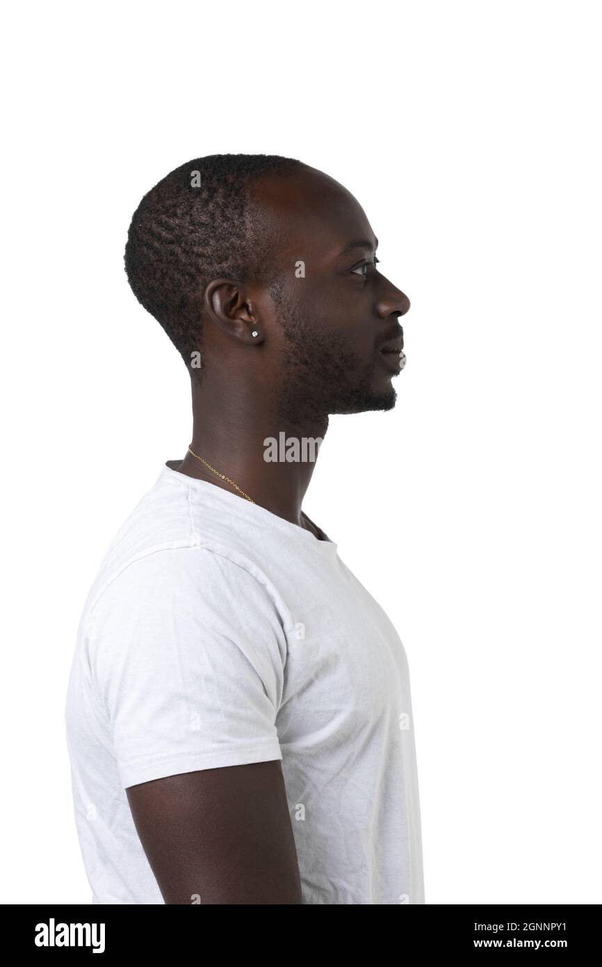 African boy in profile on a white background looks straight ahead. Copy ...