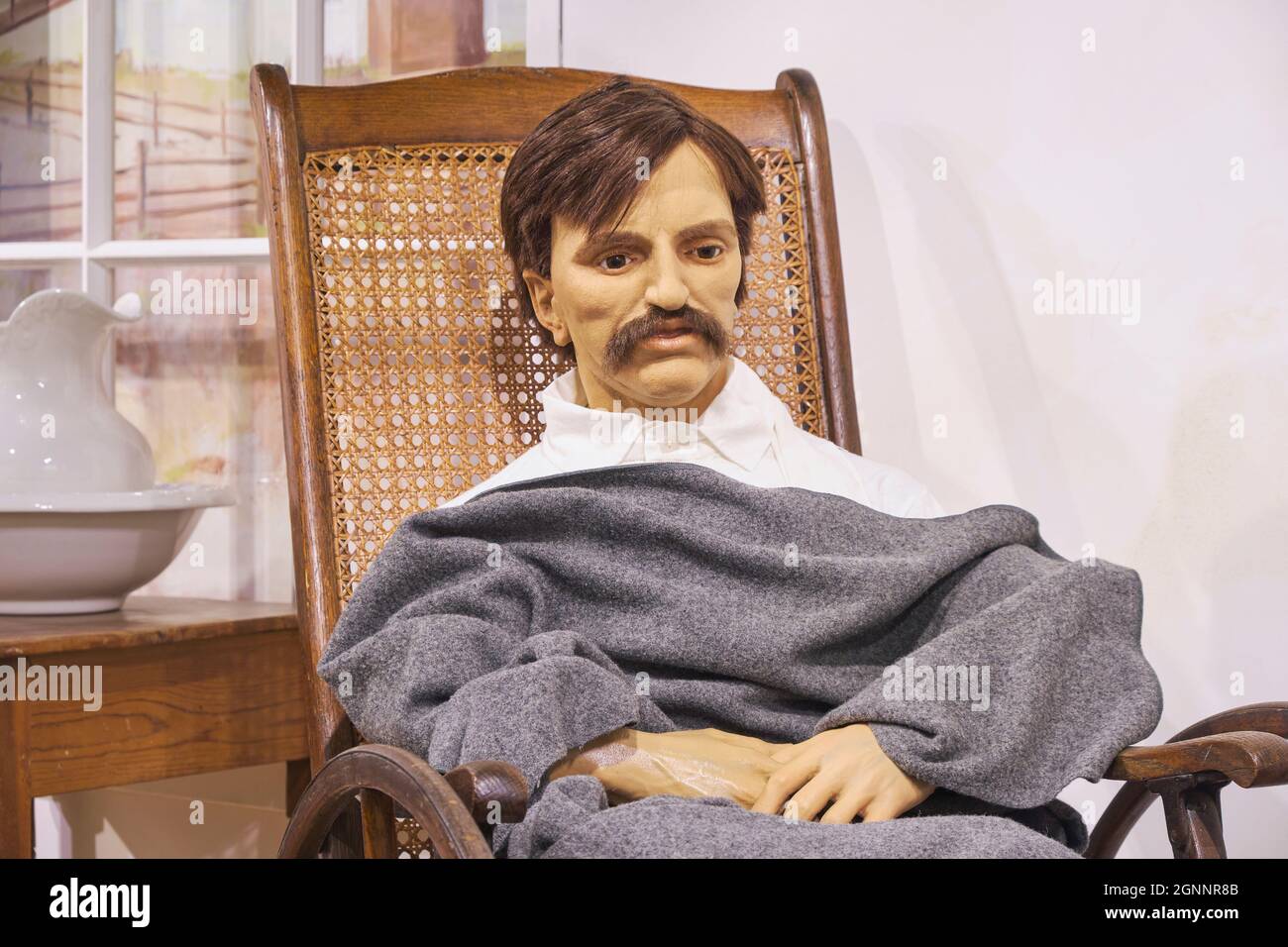 A wounded soldier sitting in a wicker wheelchair. At the National Civil ...