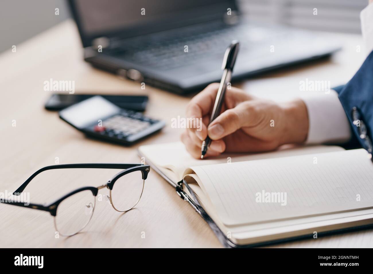 manager sitting at a desk in front of a laptop finance professional ...