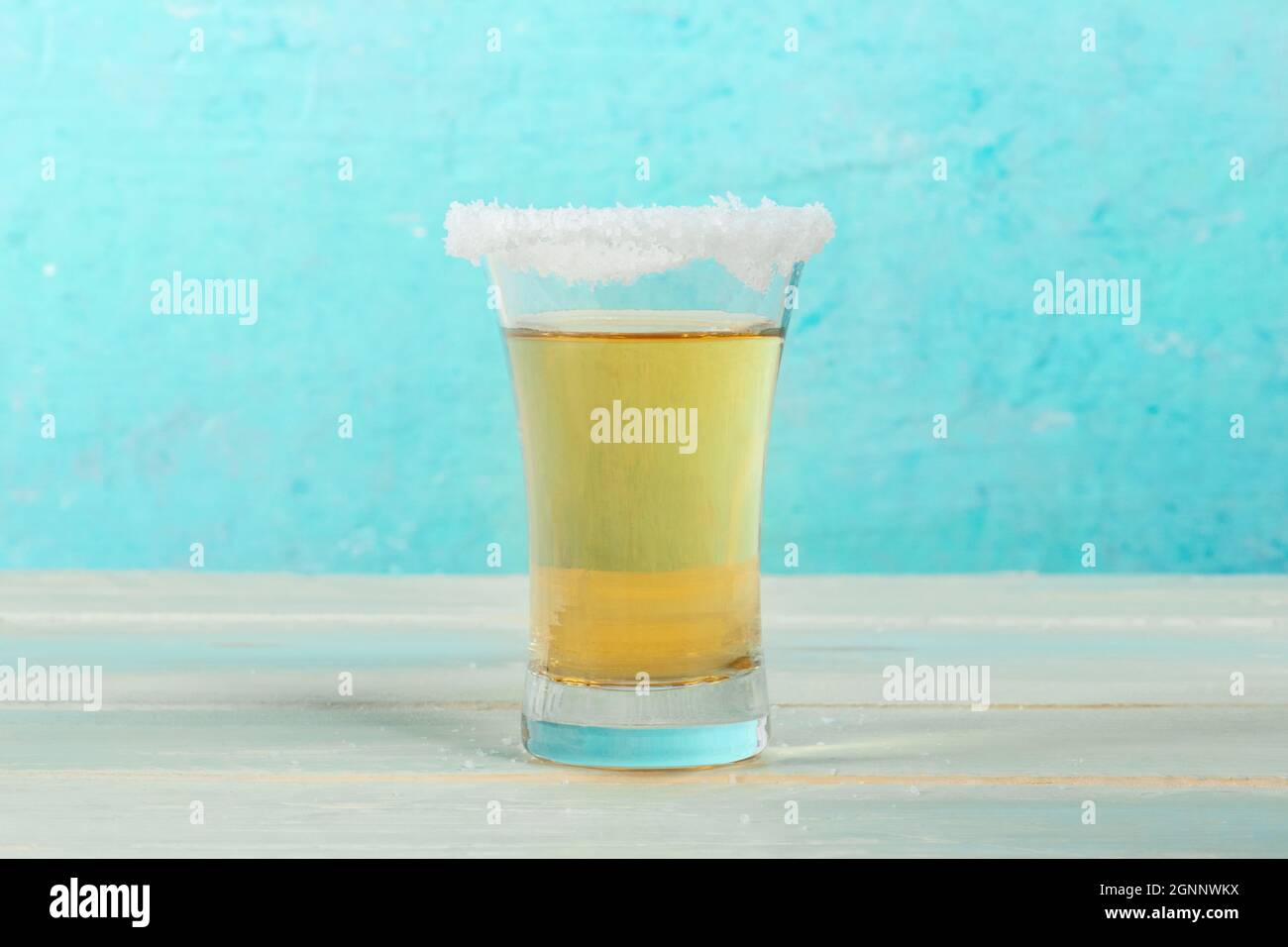 Tequila shot, a Mexican drink on a vibrant blue background, with a ...