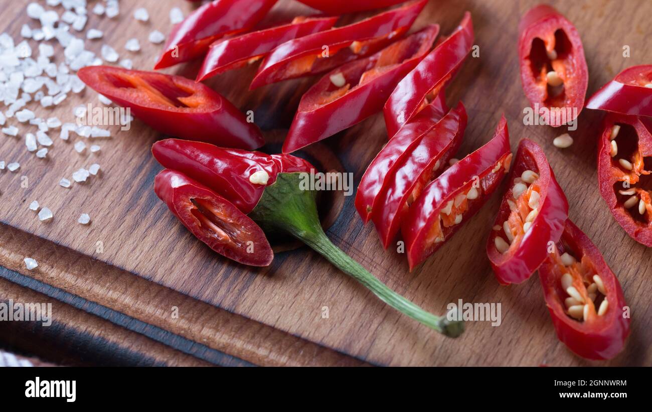 chili peppers, sliced on a kitchen board, macro Stock Photo - Alamy