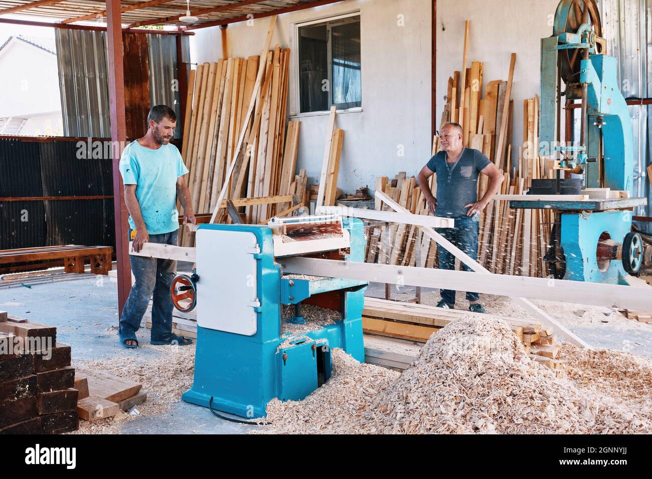 July, 2021 - Urla, Izmir, Turkey: Carpenter woodworker holds a timber ...