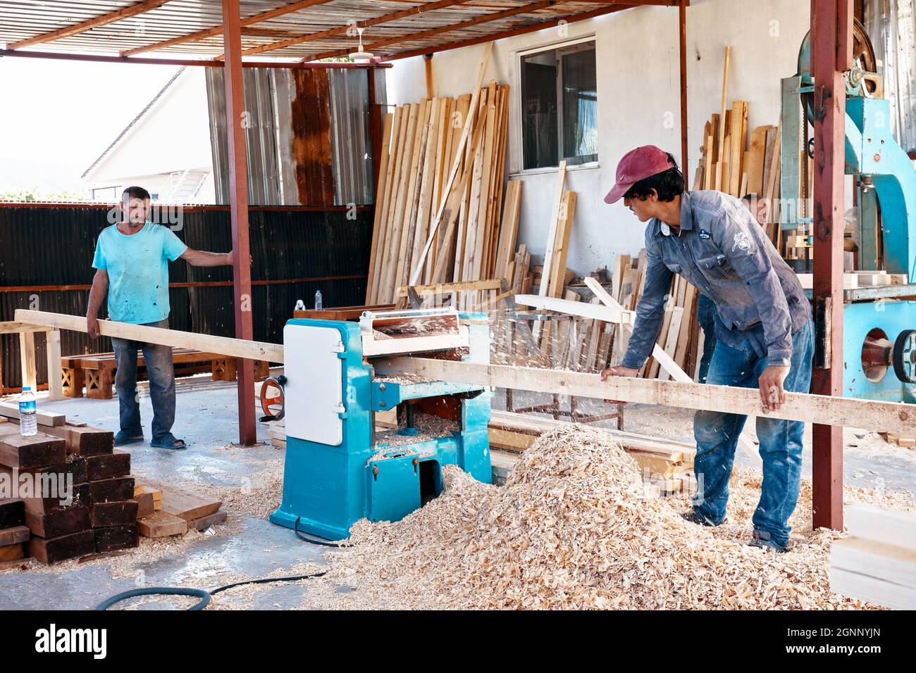 July, 2021 - Urla, Izmir, Turkey: Carpenter woodworkers holding a ...