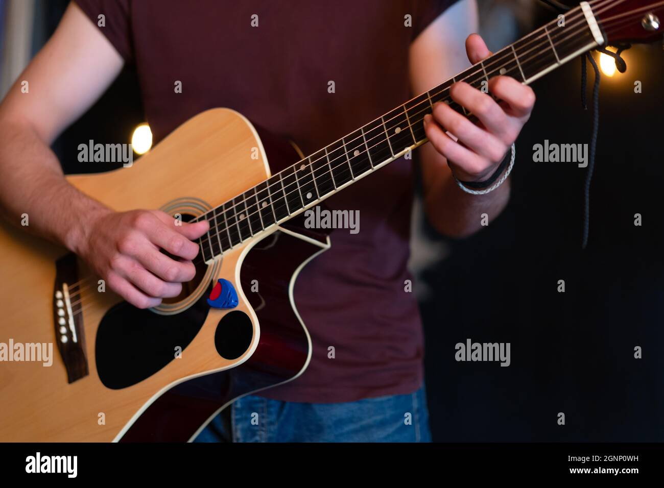 Male musician playing acoustic guitar. Guitarist plays classical guitar ...