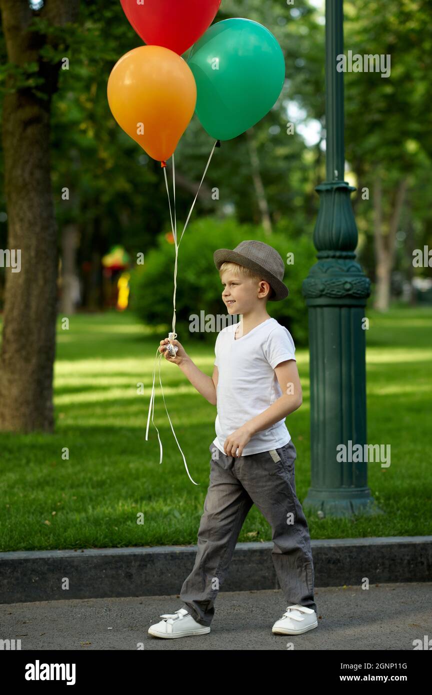 Boy with air balloons waiting for a girl Stock Photo - Alamy