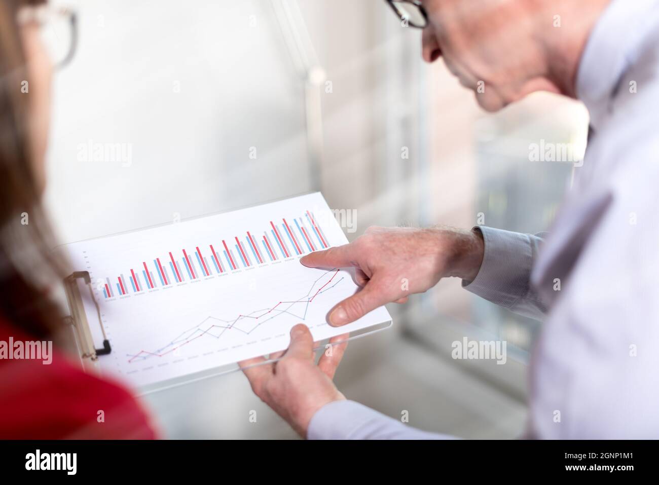 Business people in meeting discussing about financial results in office ...