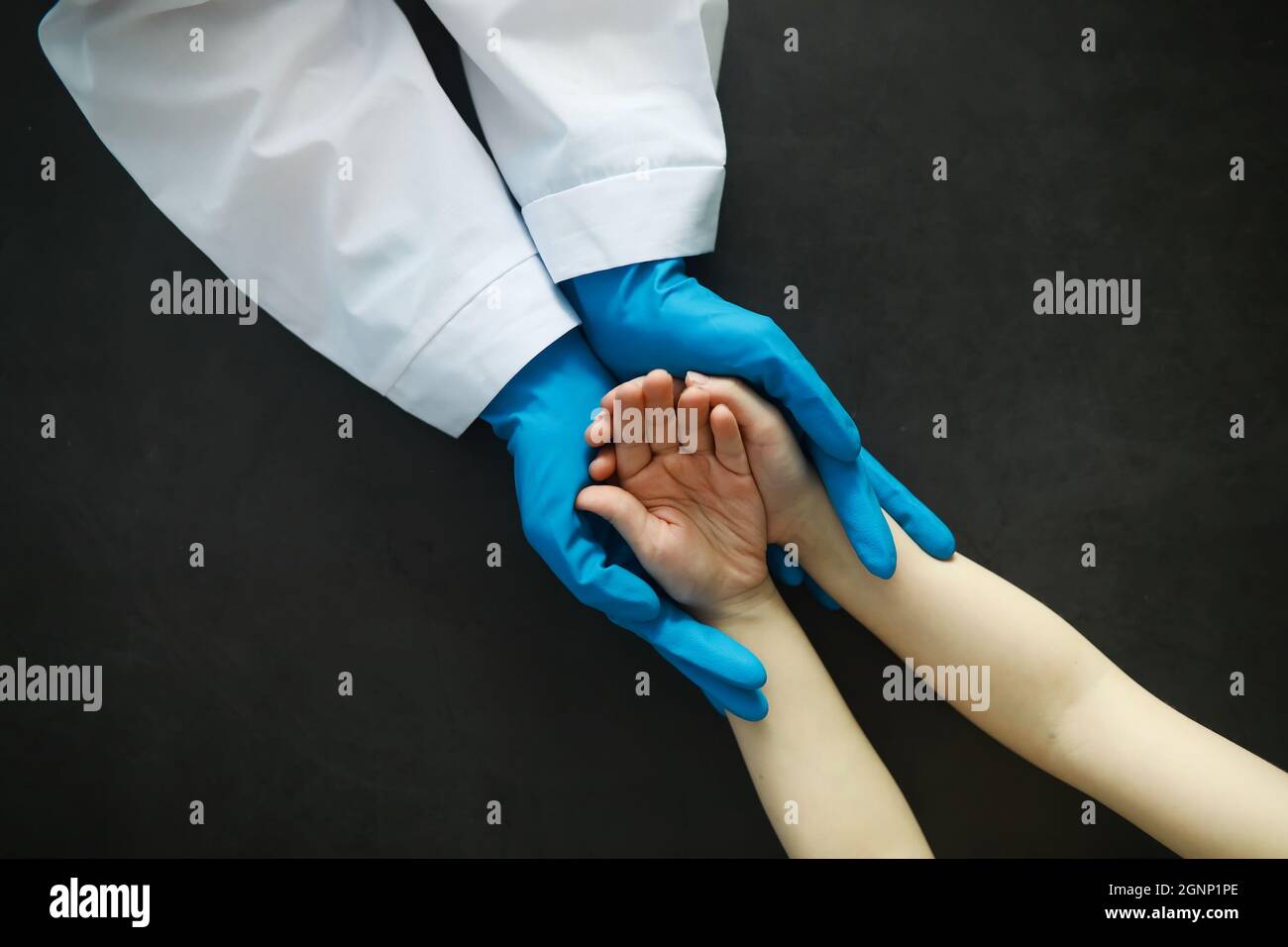 Medical concept. The doctor in gloves holds patient's hand. The moral ...