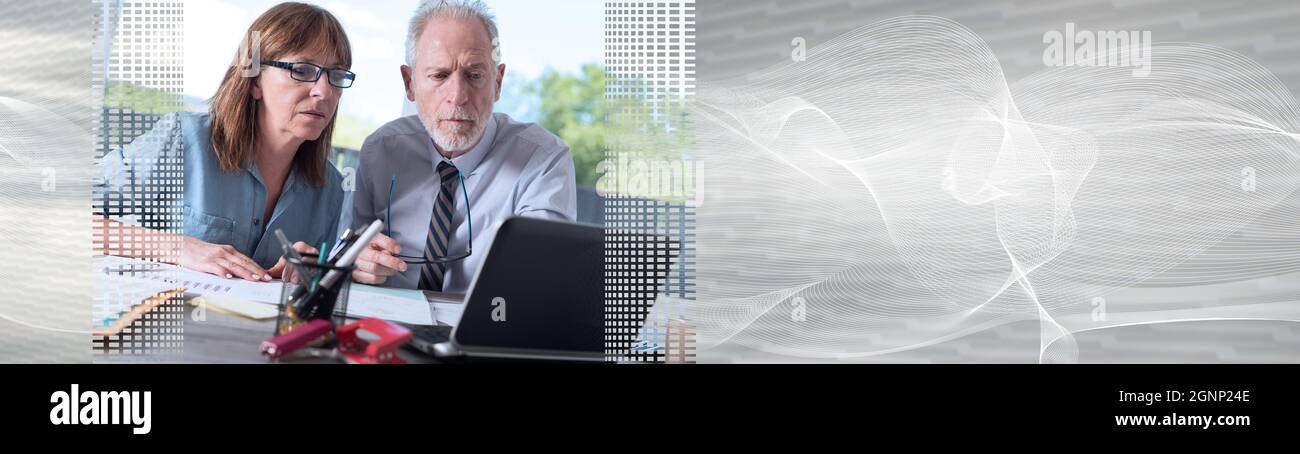 Two mature business people working together in office. panoramic banner ...