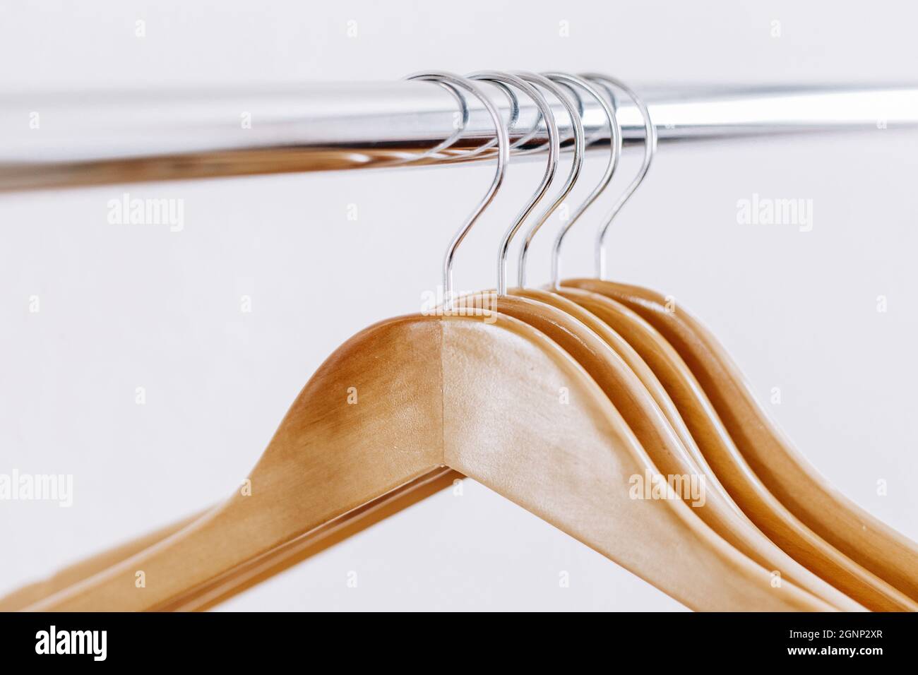Empty wooden hangers for clothes Stock Photo - Alamy