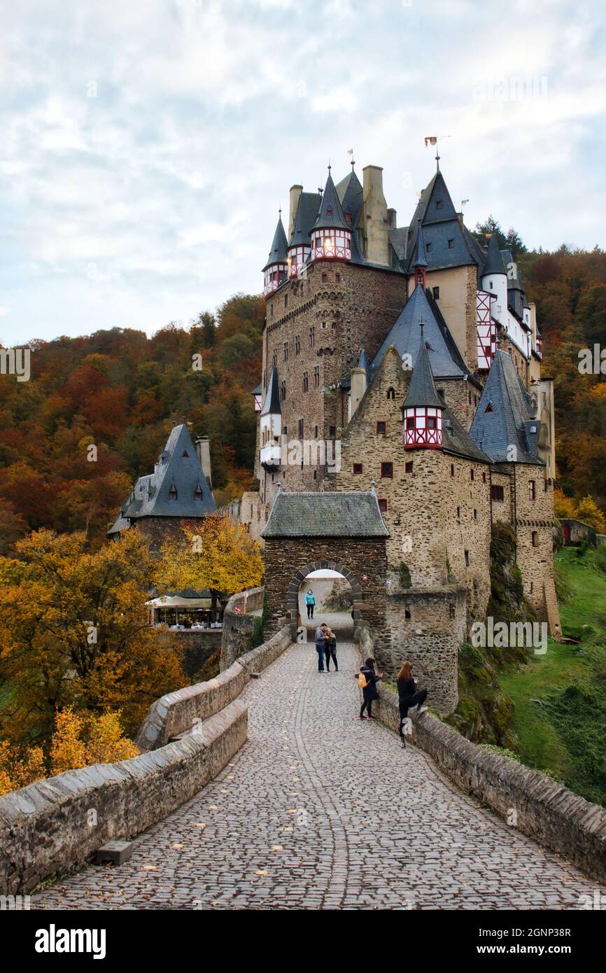 Bridge and Eltz Castle in the colorful trees of the Eifel Forest of ...
