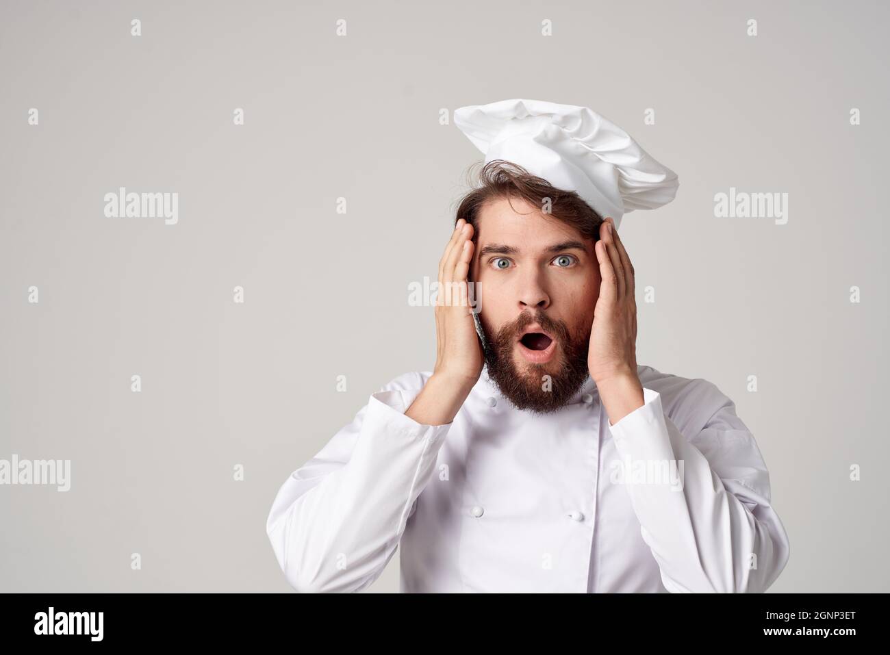 male cook Chef uniform Cooking emotions posing studio Stock Photo - Alamy