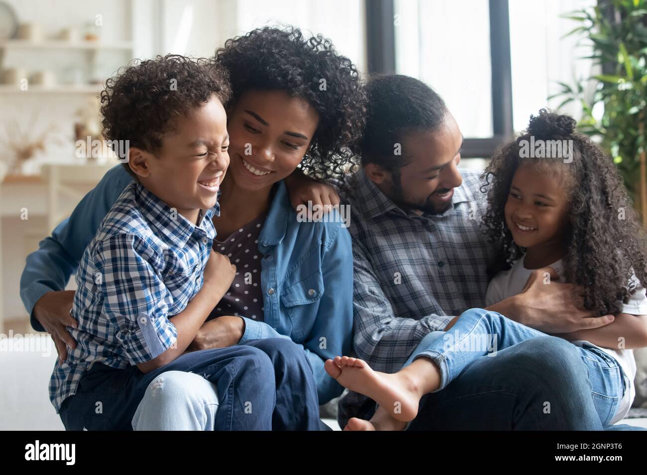 Happy African American parents with two kids having fun Stock Photo - Alamy