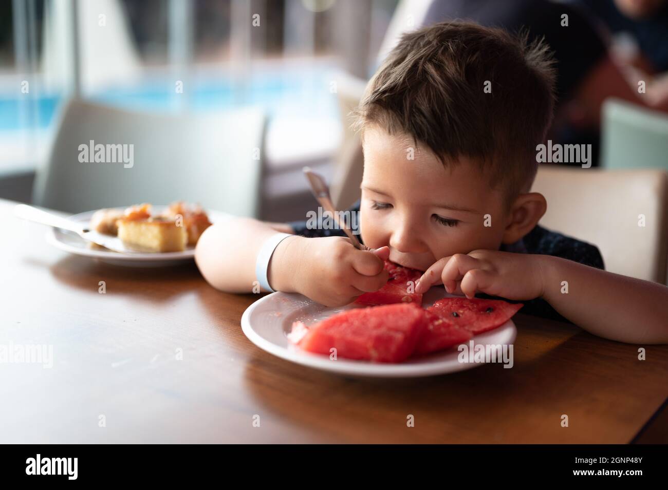 The child loves to eat watermelon Stock Photo - Alamy