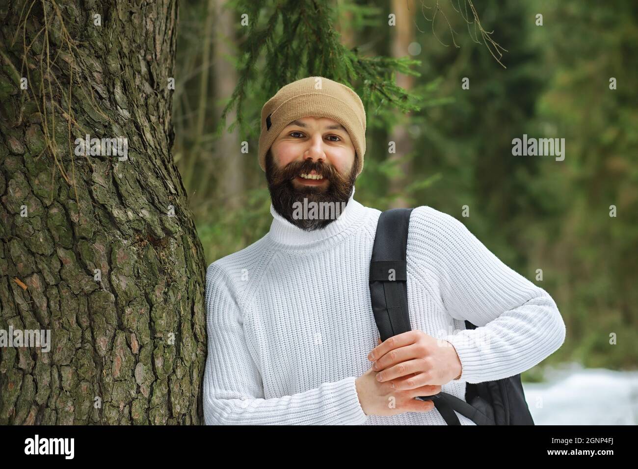 Outdoor portrait of handsome man in coat and scurf. Bearded man in the ...