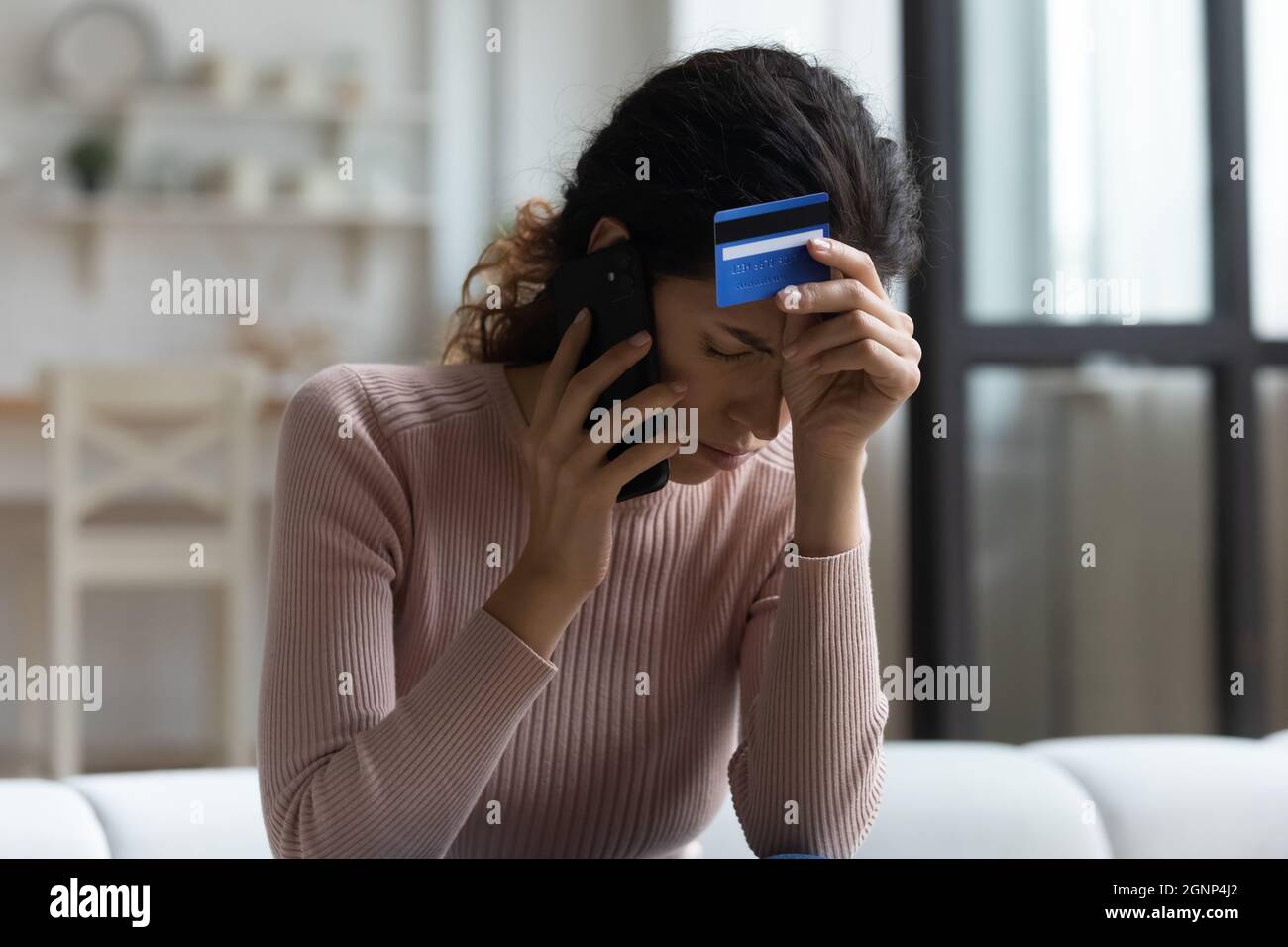 Unhappy woman distressed with credit card debt Stock Photo - Alamy