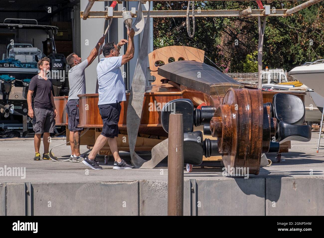 The launching of the violin-shaped boat Stock Photo - Alamy