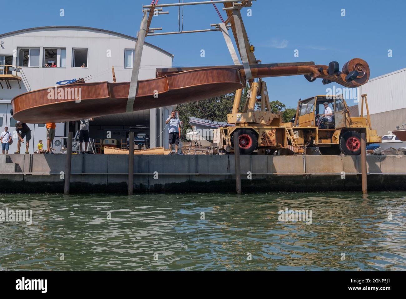 The launching of the violin-shaped boat Stock Photo - Alamy
