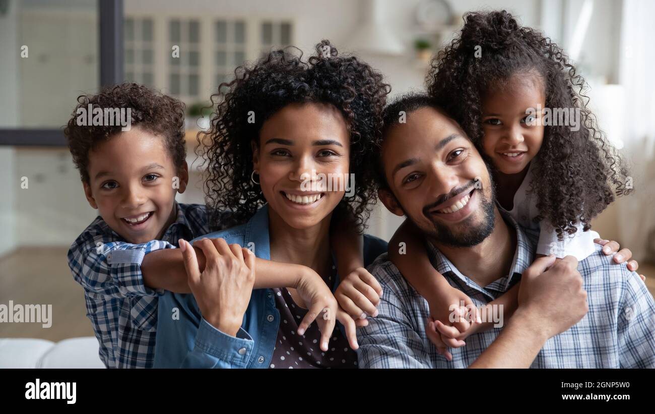 Head shot portrait of African American parents piggy backing kids Stock ...
