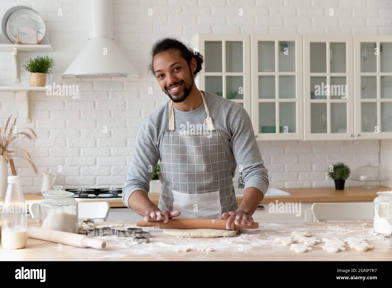 Head shot portrait smiling African American man rolling out dough Stock ...