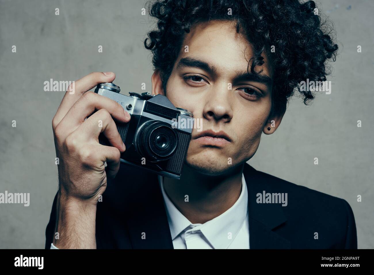 elegant curly man in suit with cameras close up Stock Photo - Alamy