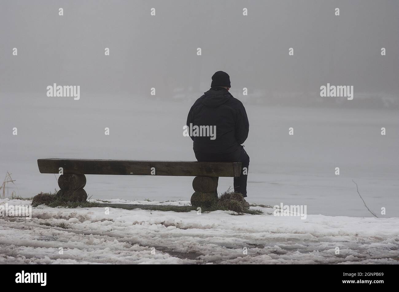 Man sits alone on a bench in snow, Germany Stock Photo - Alamy