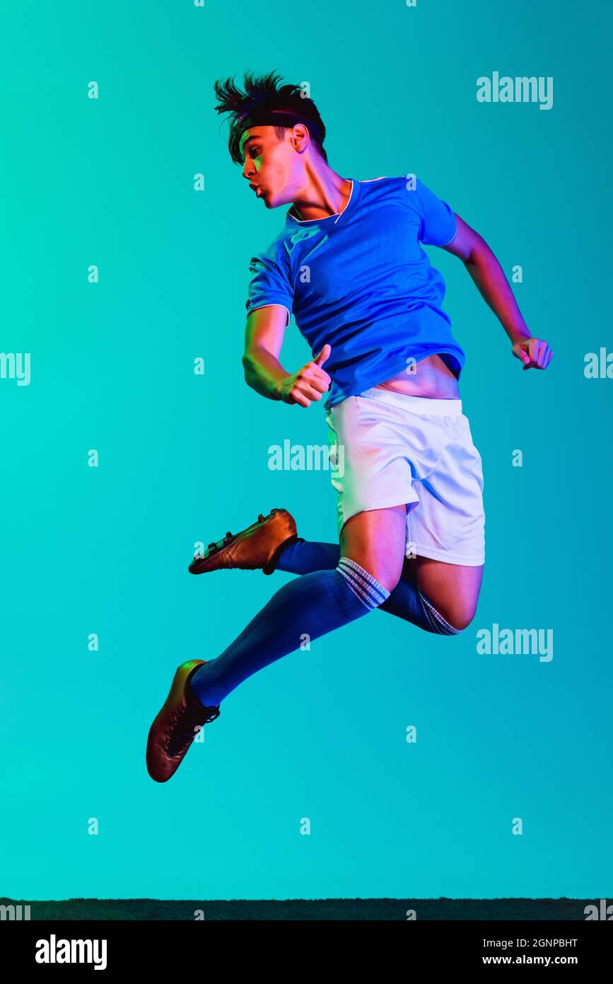 Full-length vertical portrait of young man, soccer football player ...