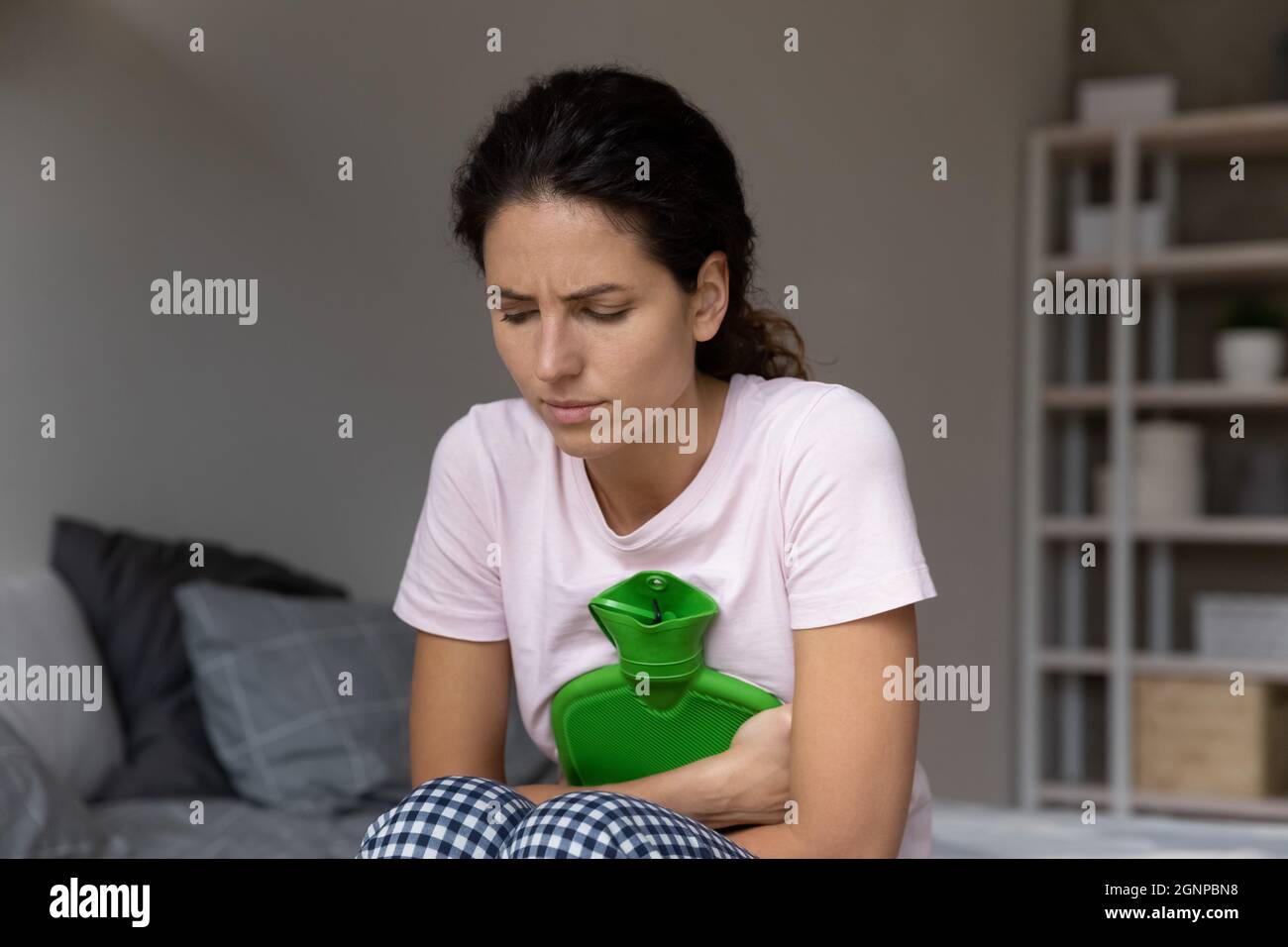 Unhealthy woman use warmer suffer from stomachache Stock Photo - Alamy Unhealthy woman use warmer suffer from stomachache Stock Photo - Alamy