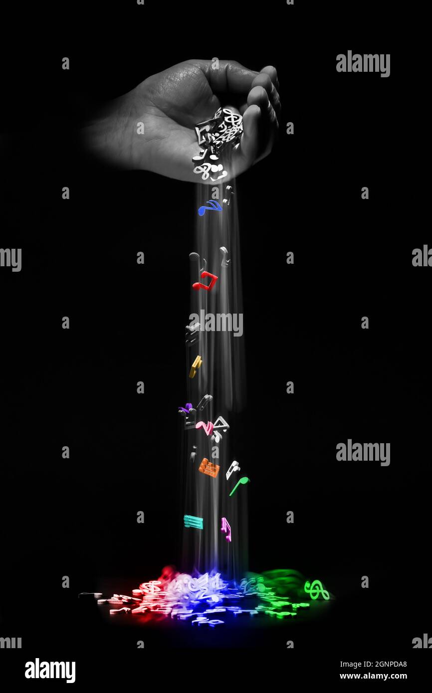 Multi-colored musical notes pouring from the hand, on a black ...