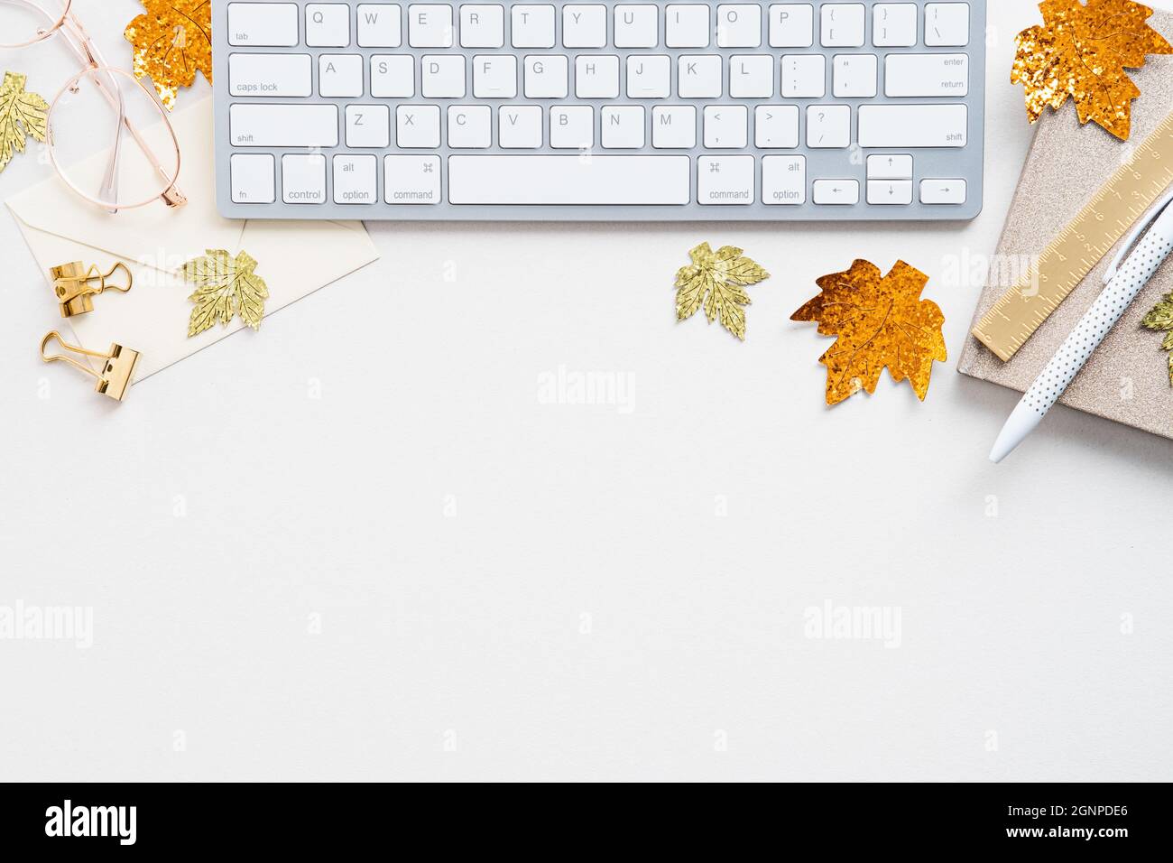 Autumn desk table with computer keyboard, maple leaves, notebook on ...