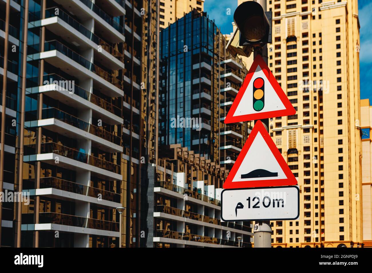 Traffic light and speed bump road sign in Dubai Stock Photo - Alamy
