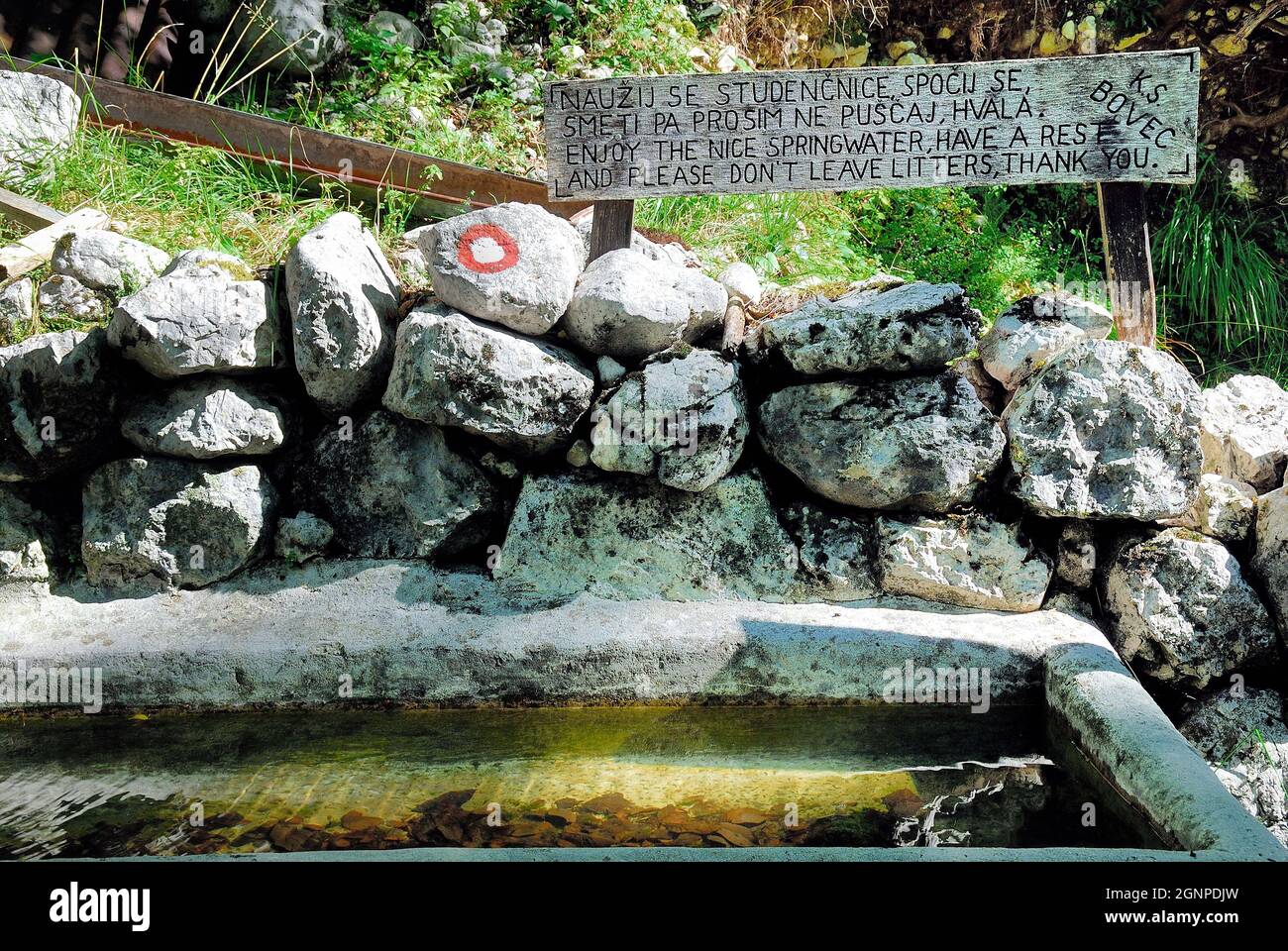 Slovenia, Bovec, the path for the mount Rombon. A fountain with ...