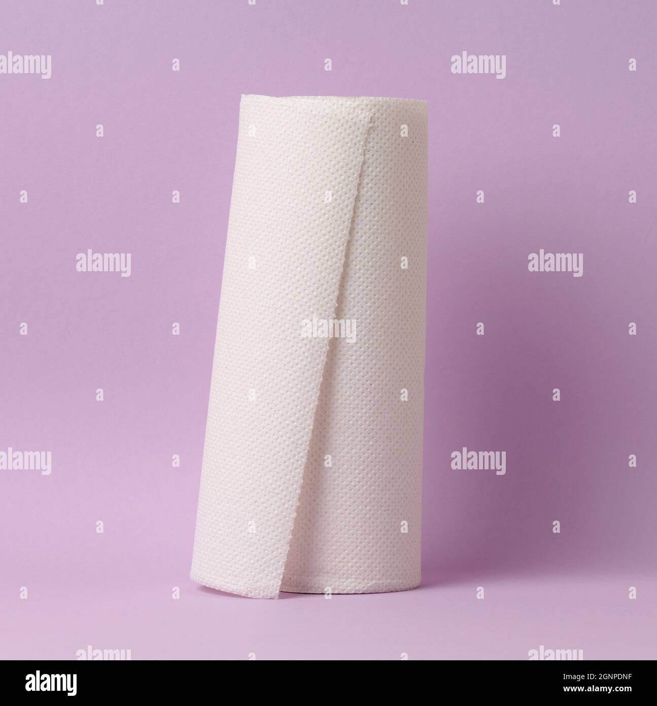 Soft white paper towel on a purple background, disposable kitchen towel ...