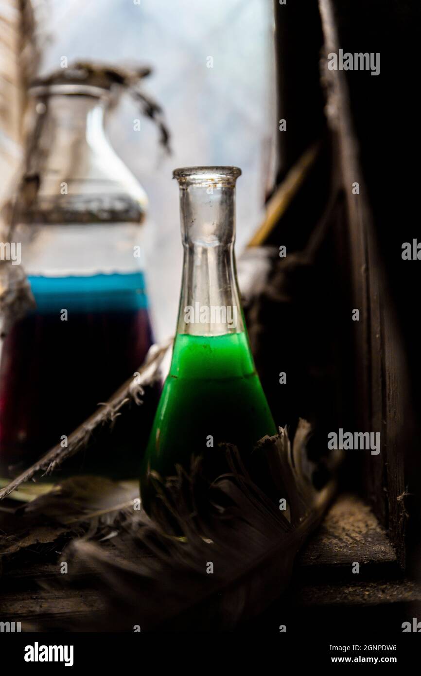 Magic potions in bottles near old rustic window with backlight ...