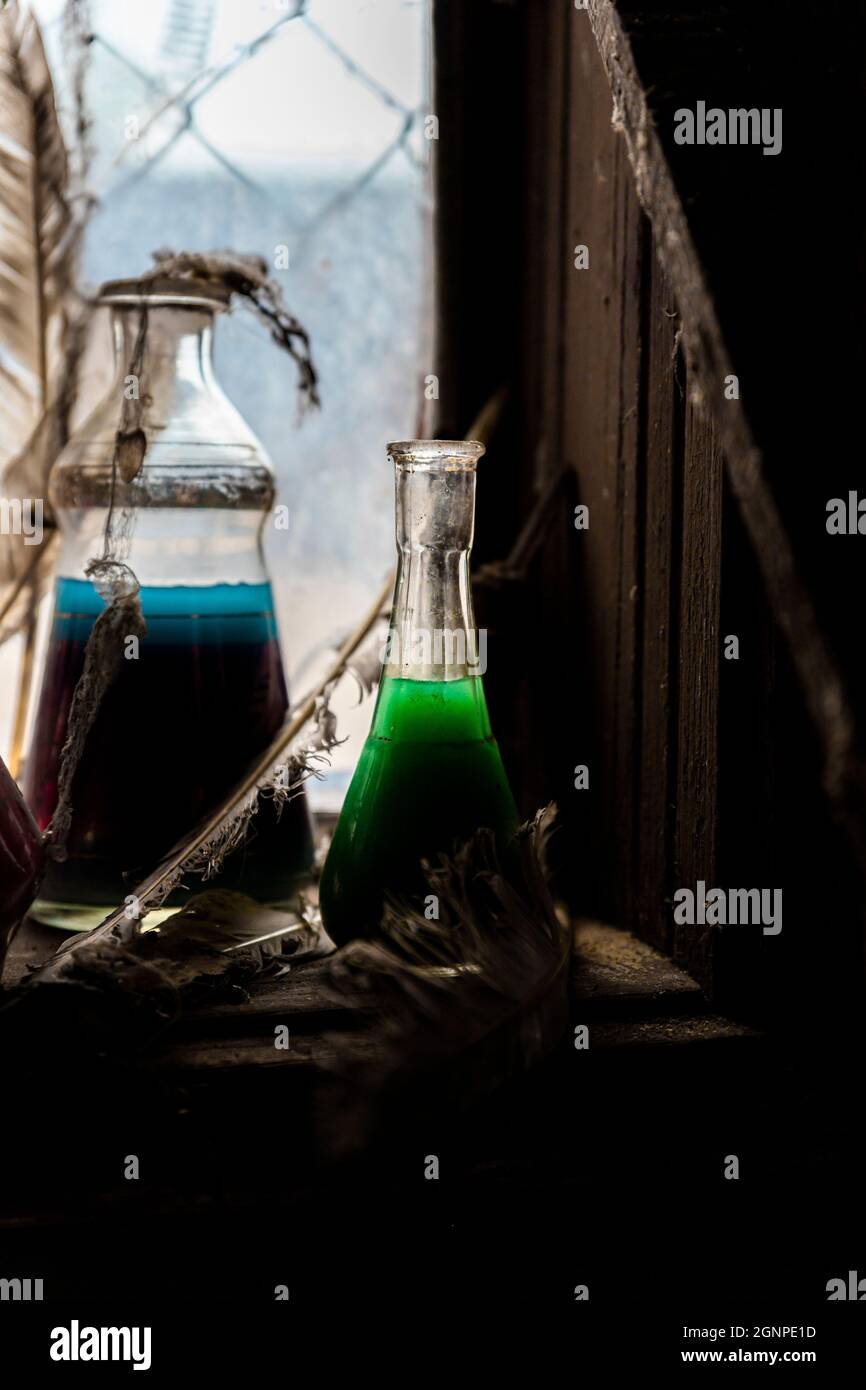 Magic potions in bottles near old rustic window with backlight ...