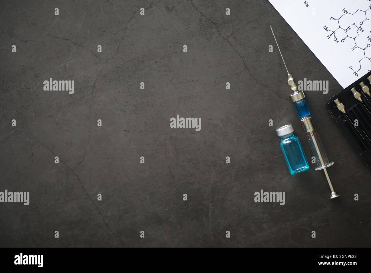 small jars with injection and syringe for injection on blue background ...