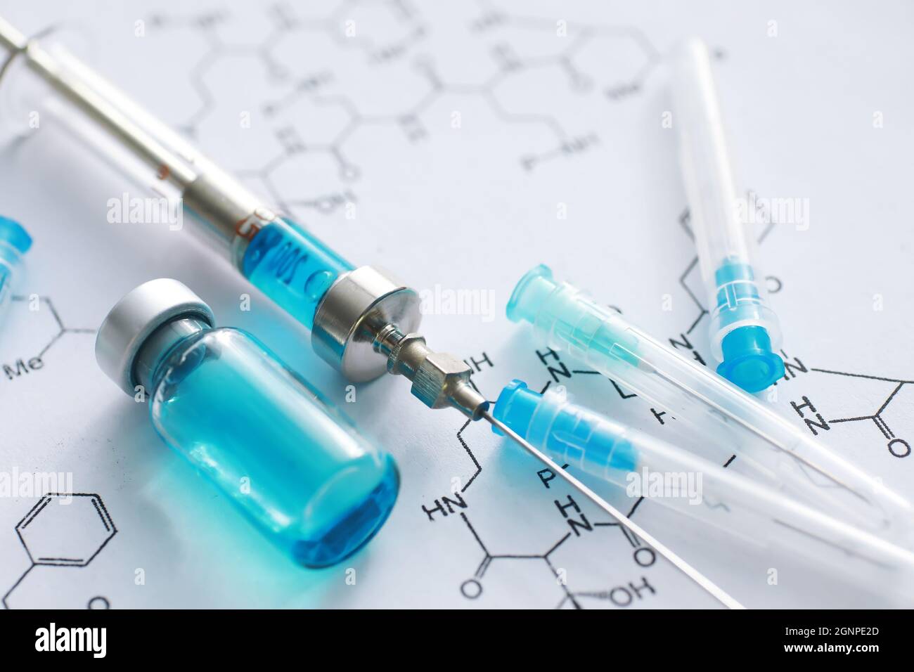 small jars with injection and syringe for injection on blue background ...