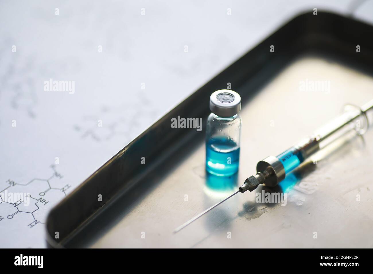 small jars with injection and syringe for injection on blue background ...