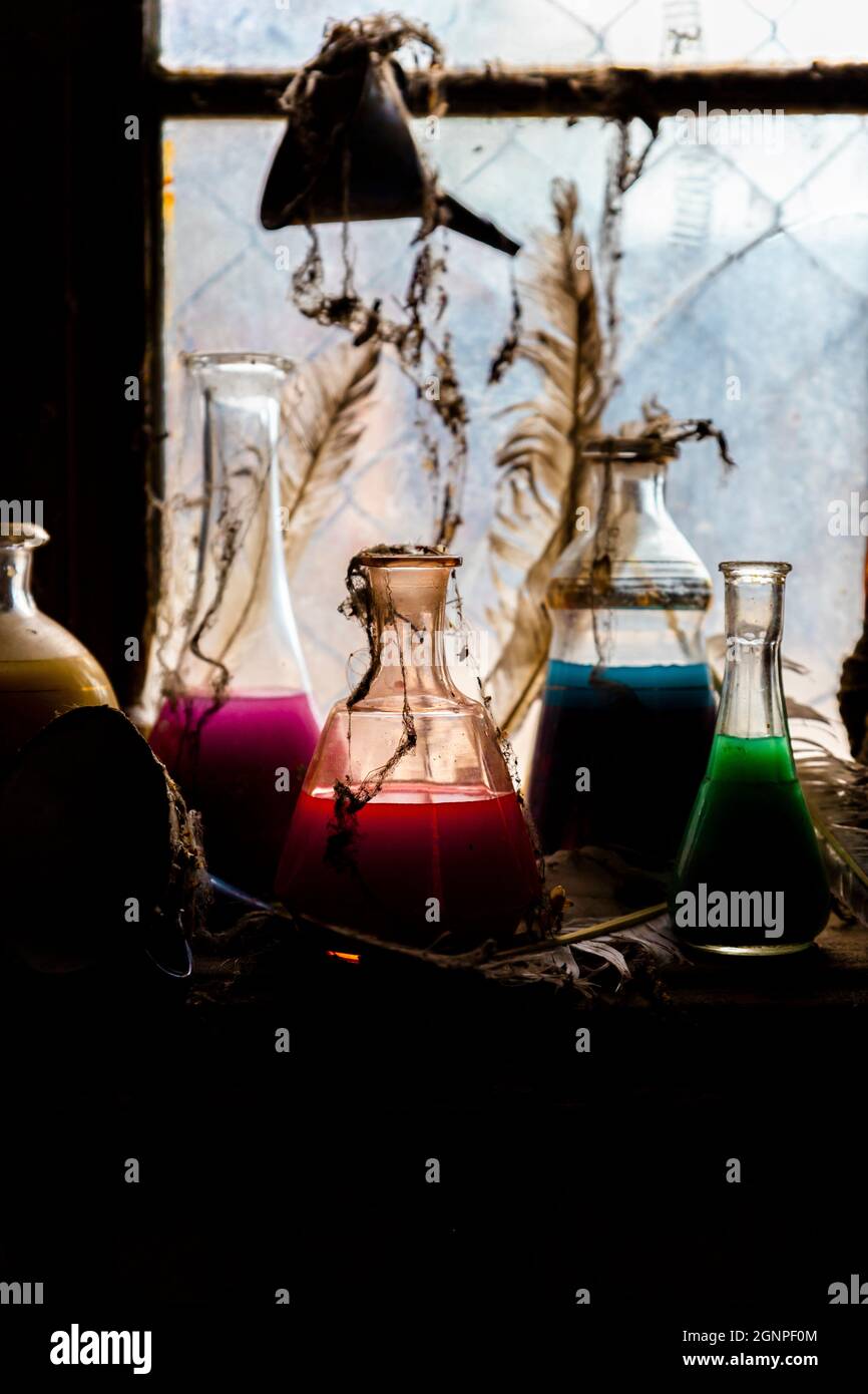 Magic potions in bottles near old rustic window with backlight ...