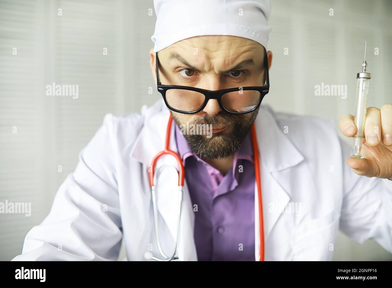 A cross-eyed bearded man is looking into the frame. Eye disease. The ...