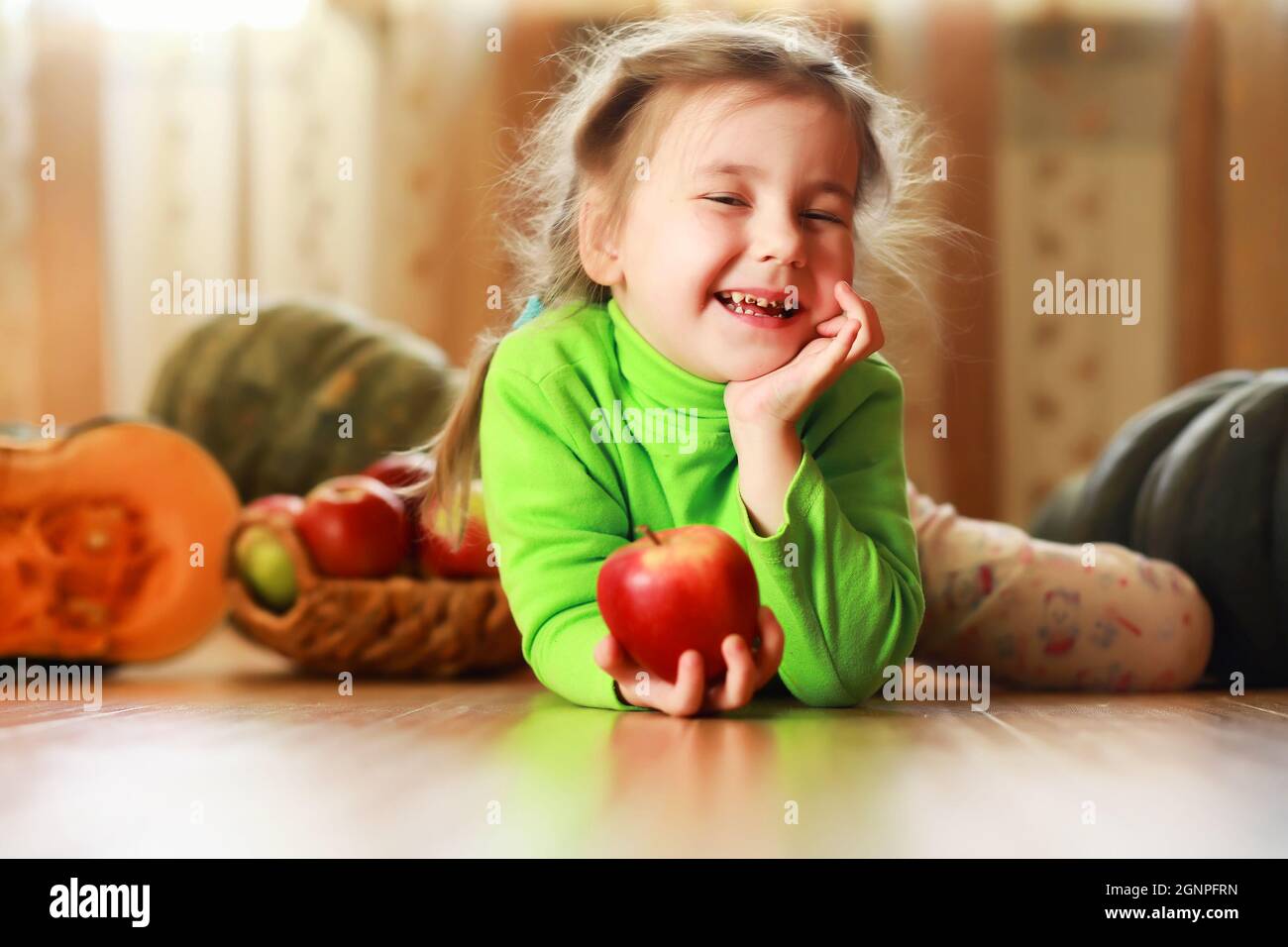 Little child choose a pumpkin autumn. Child sitting on giant pumpkin ...
